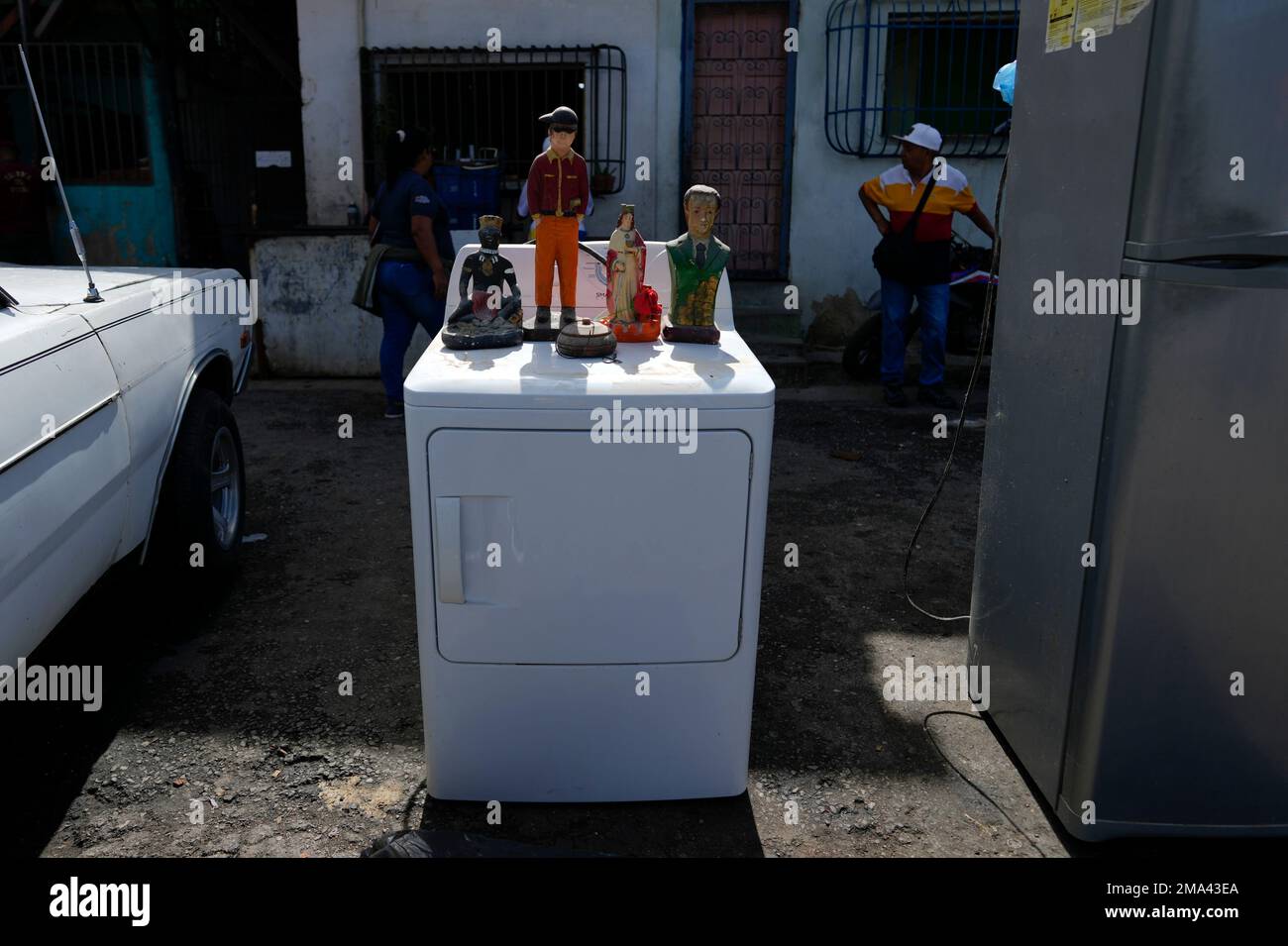 Religious statues dry on a clothes dryer as residents evacuate the 23 ...