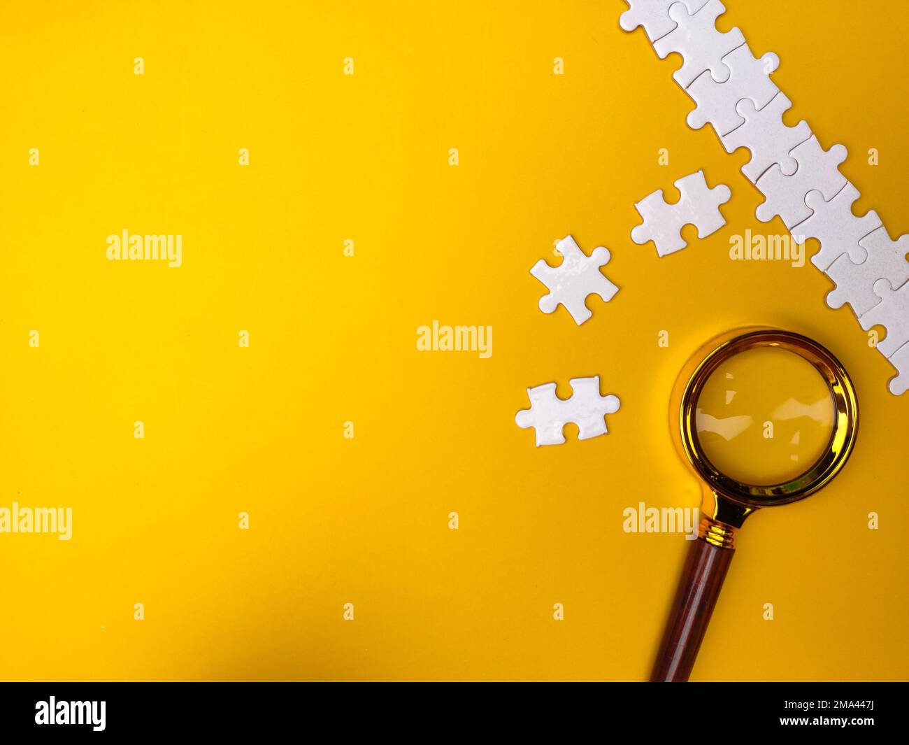 Magnifying glass searching missing puzzle on yellow background Stock ...