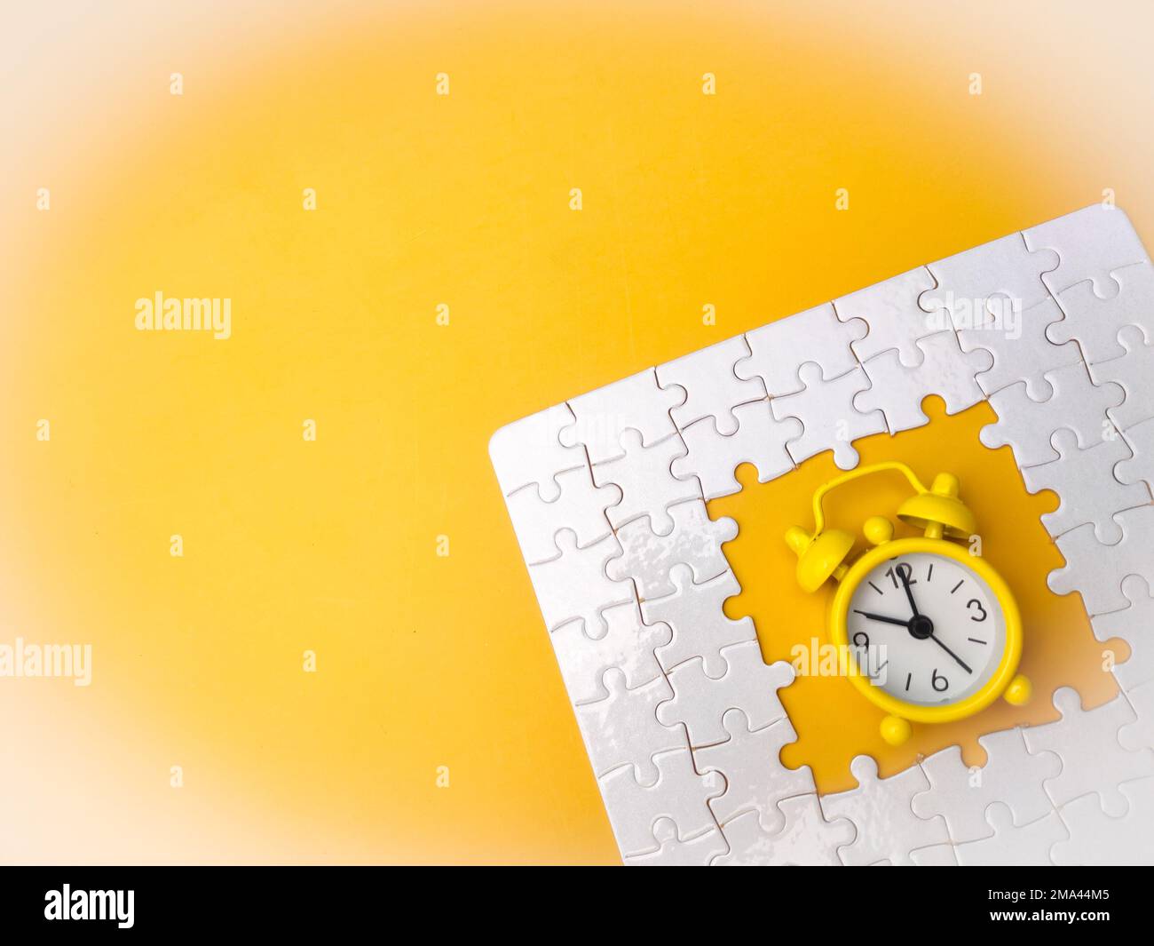 Concept yellow alarm clock and puzzle on yellow background Stock Photo ...