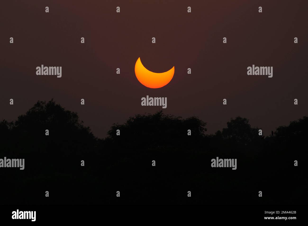 The partial solar eclipse is seen over in Lahore, Pakistan, Tuesday ...
