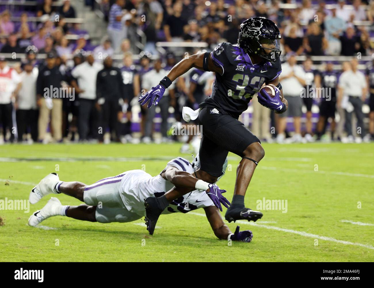 TCU running back Kendre Miller (33) runs the ball as he tripped up by ...