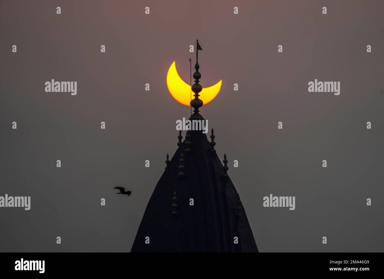 A partial solar eclipse is seen behind the centuries-old Raghunath ...