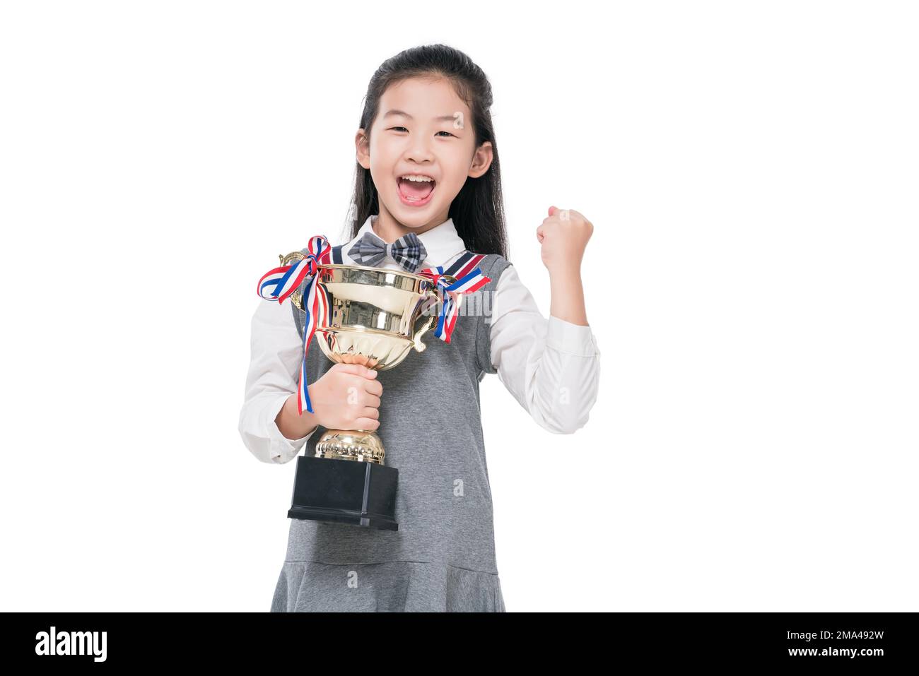 Happy primary school students holding a trophy Stock Photo - Alamy