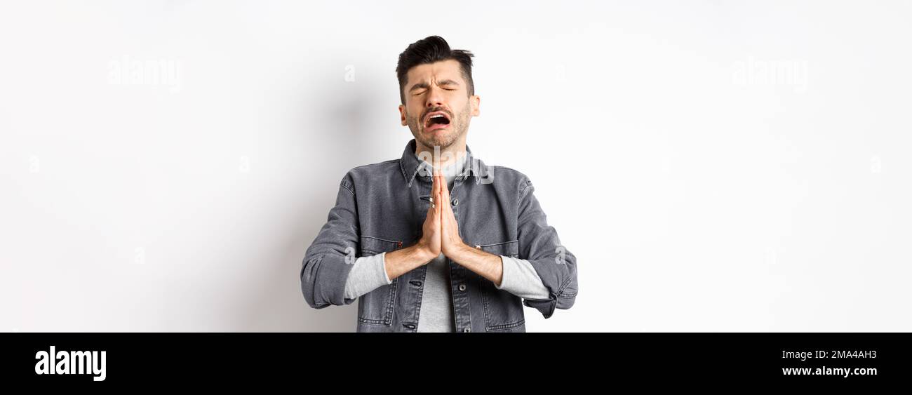 Miserable man begging for help, need something and crying, pleading ...