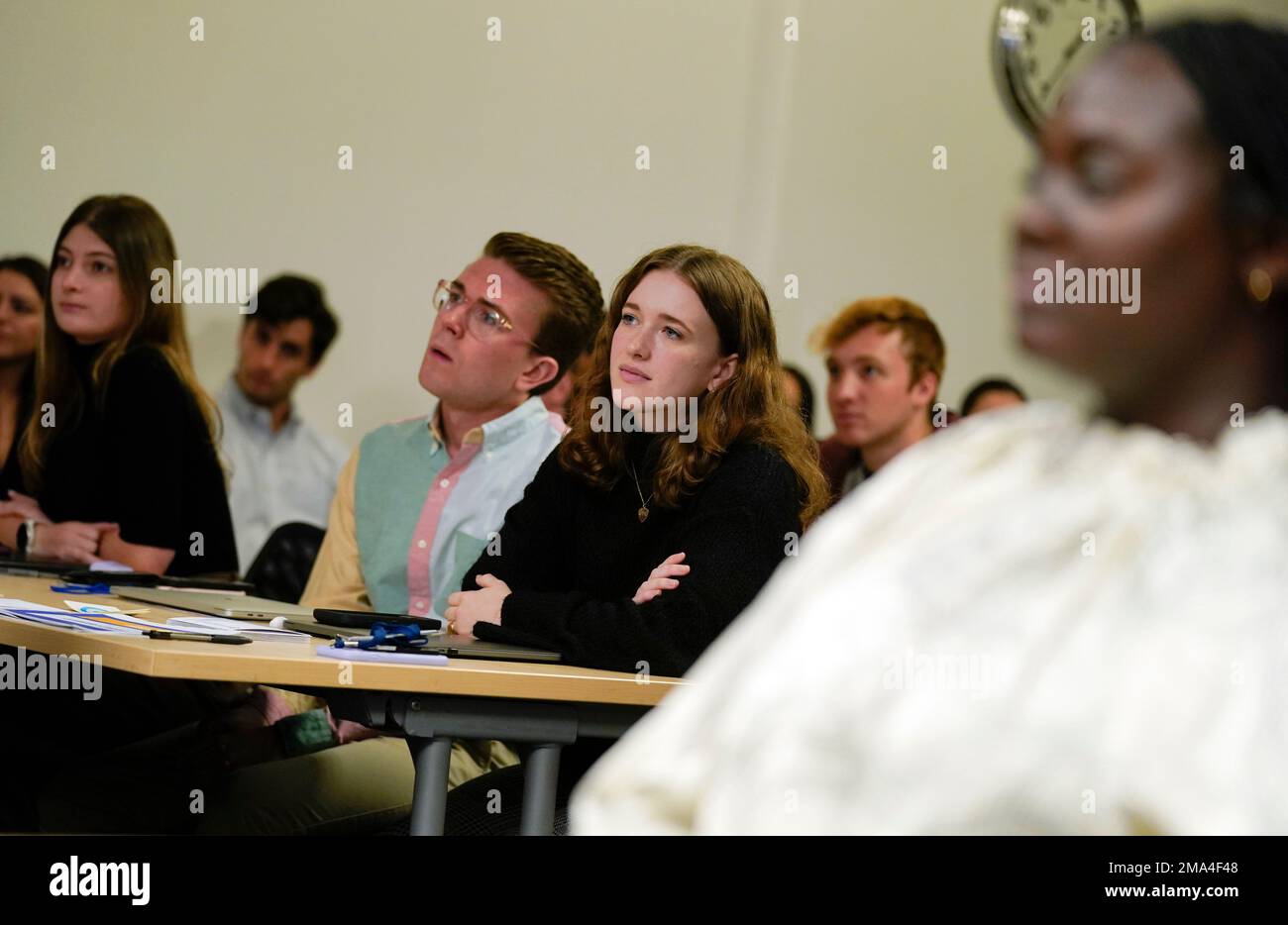 People listen as President Joe Biden speaks during a visit to the ...