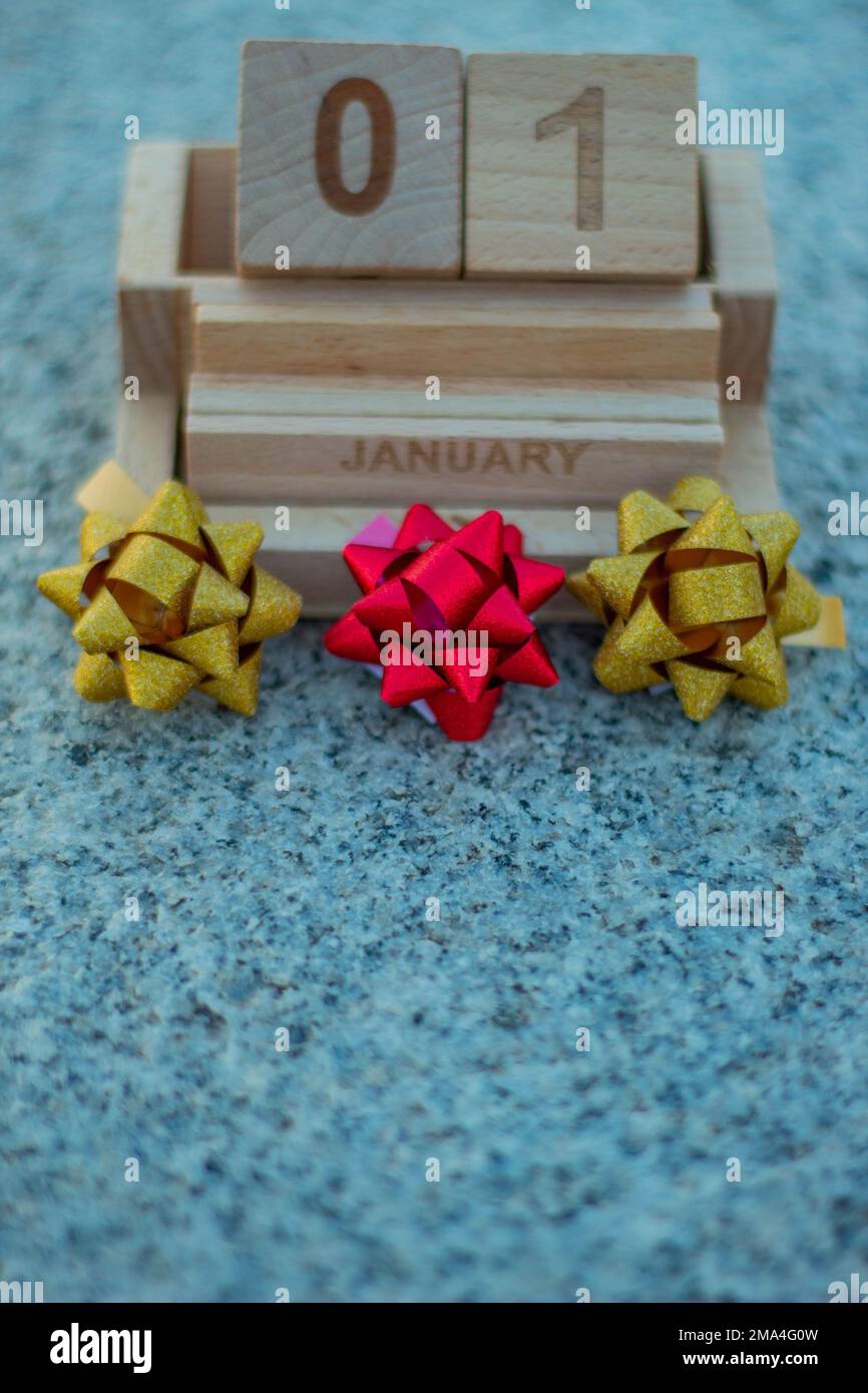 Vintage wooden calendar with Christmas gift bows with the New Year's ...