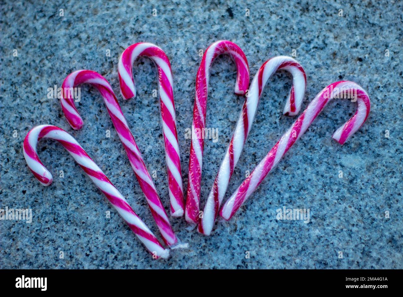Set of candy canes with red and white spirals for Christmas on a stone ...