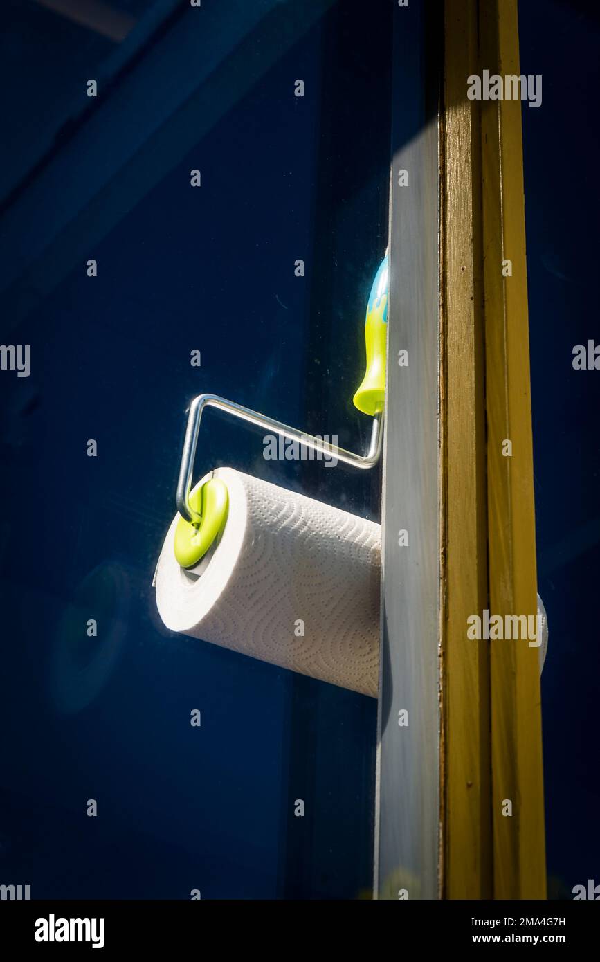 Kitchen roll hanging of a window frame Stock Photo - Alamy