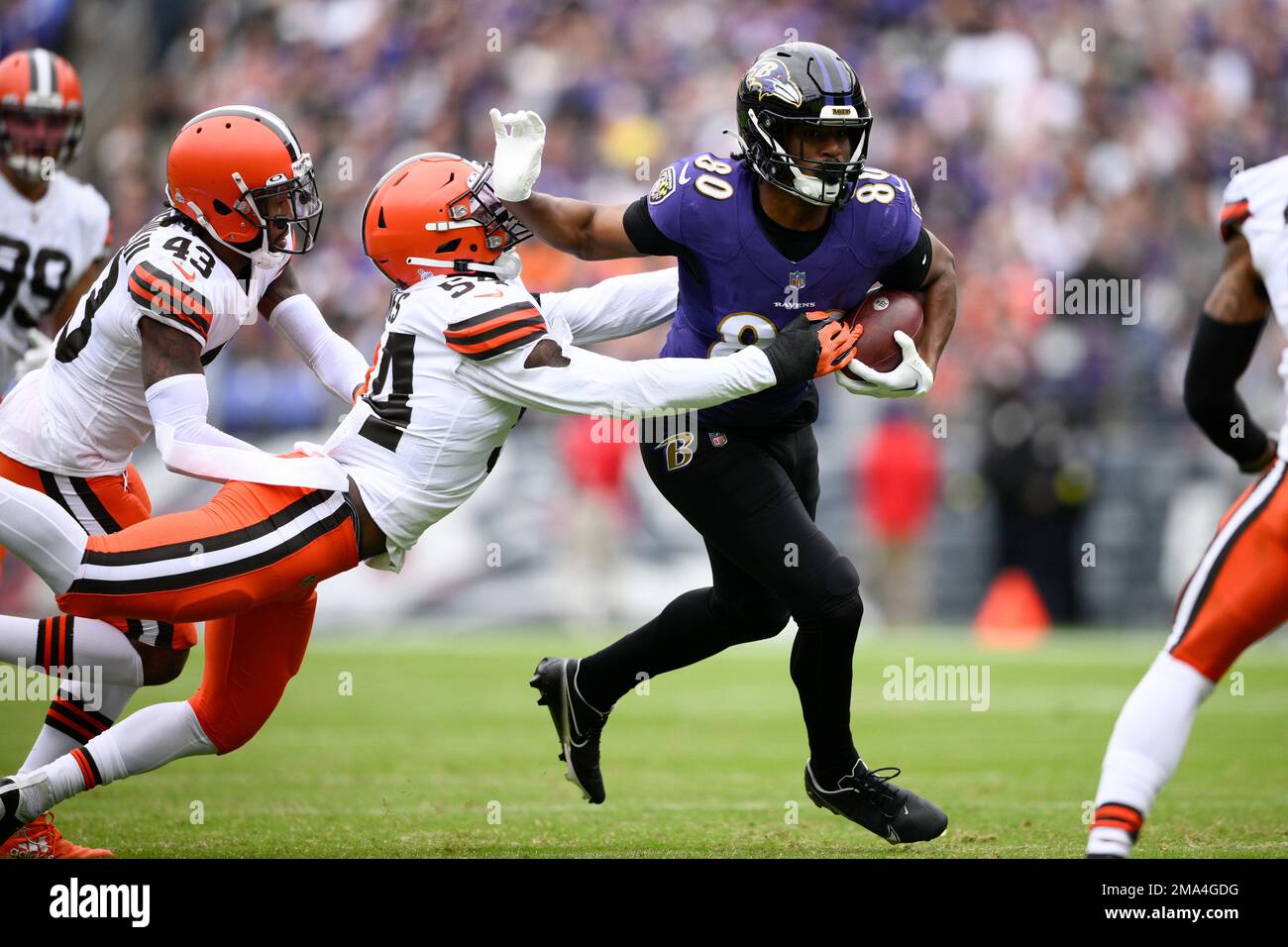 Baltimore Ravens tight end Isaiah Likely (80) is tackled by Cleveland Browns linebacker Deion ...