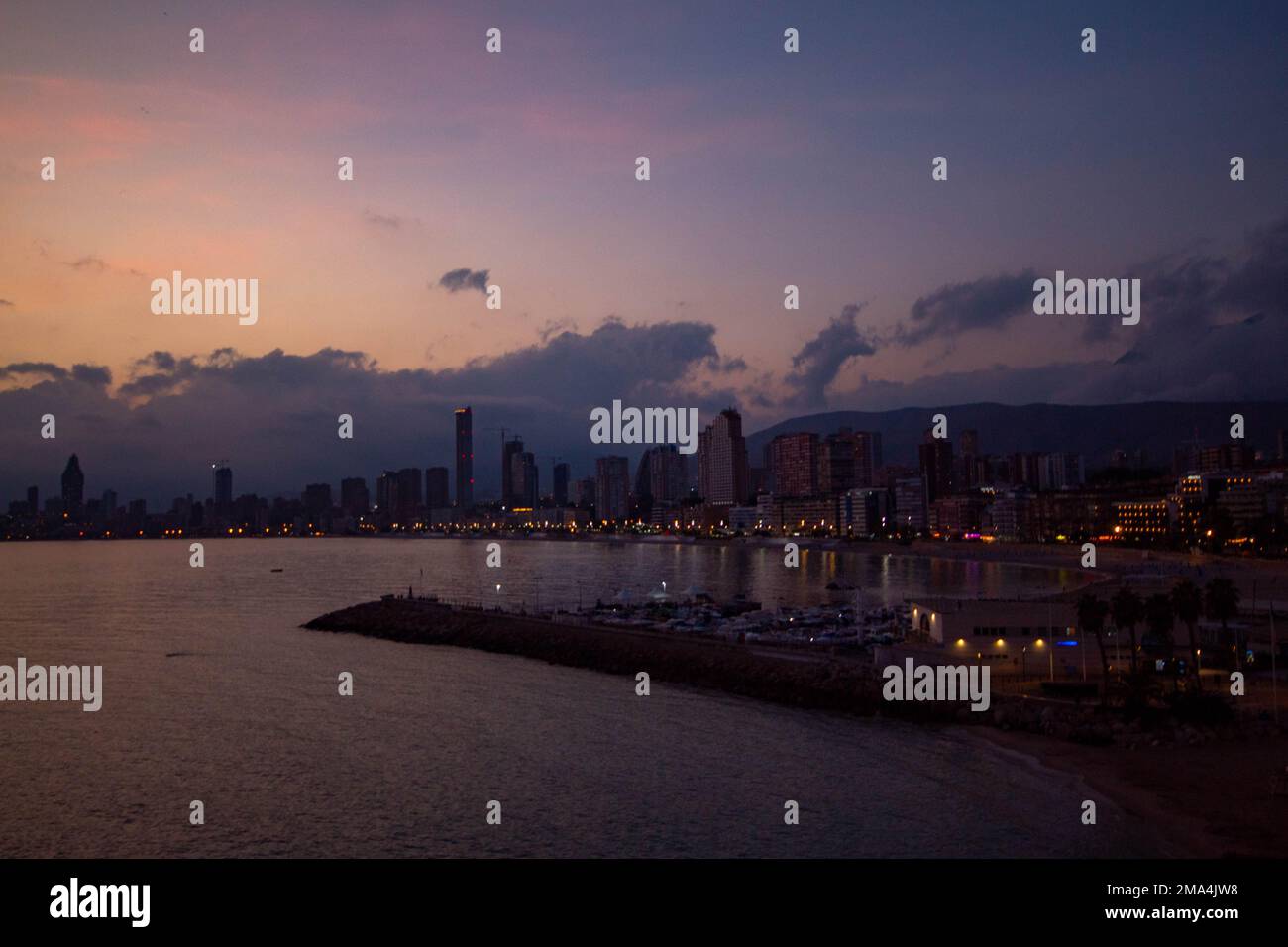 Sunset with purple colors in the sky with dark clouds in the background ...