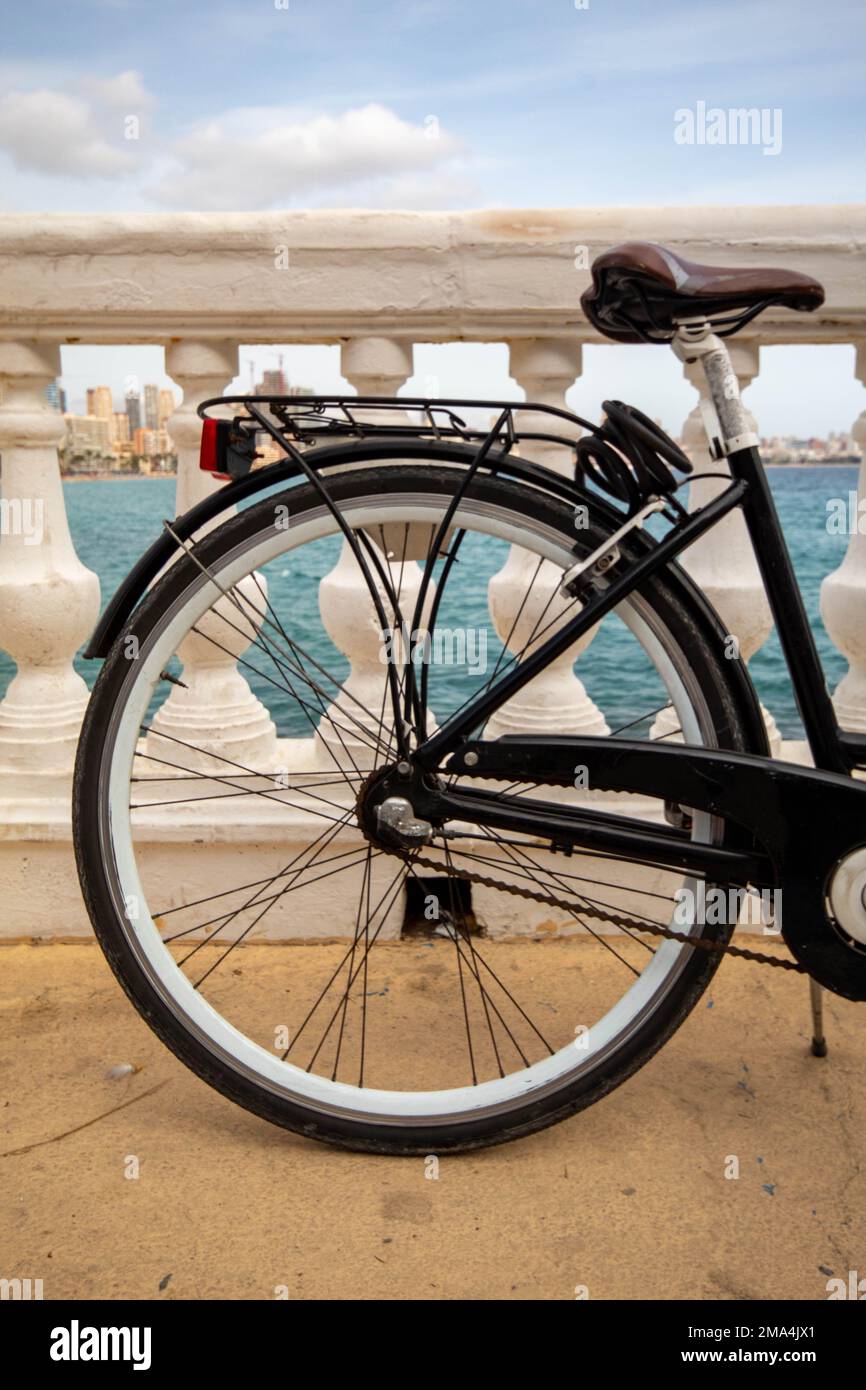 The wheel of a bicycle rented on holiday with the Mediterranean Sea in ...