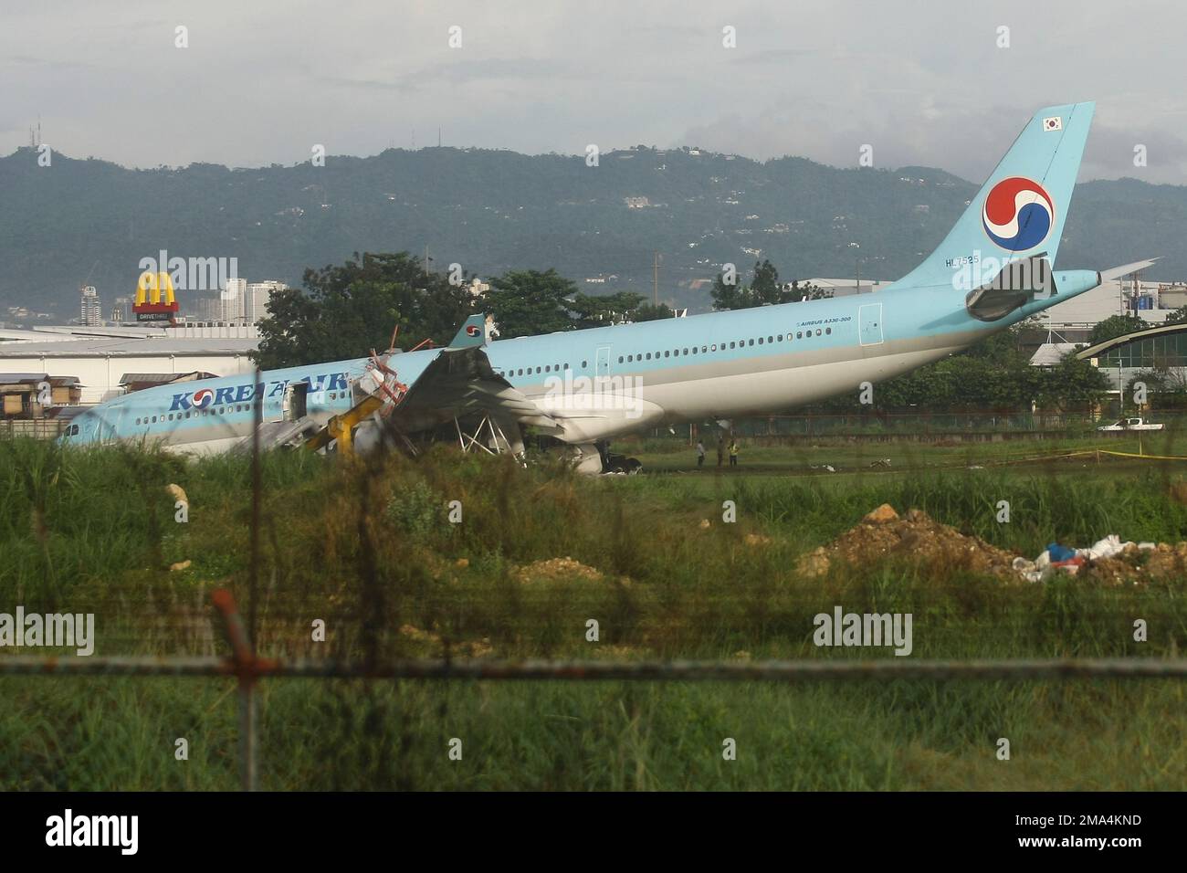 A damaged Korean Air plane lies after it overshot the runway at the Mactan-Cebu International ...