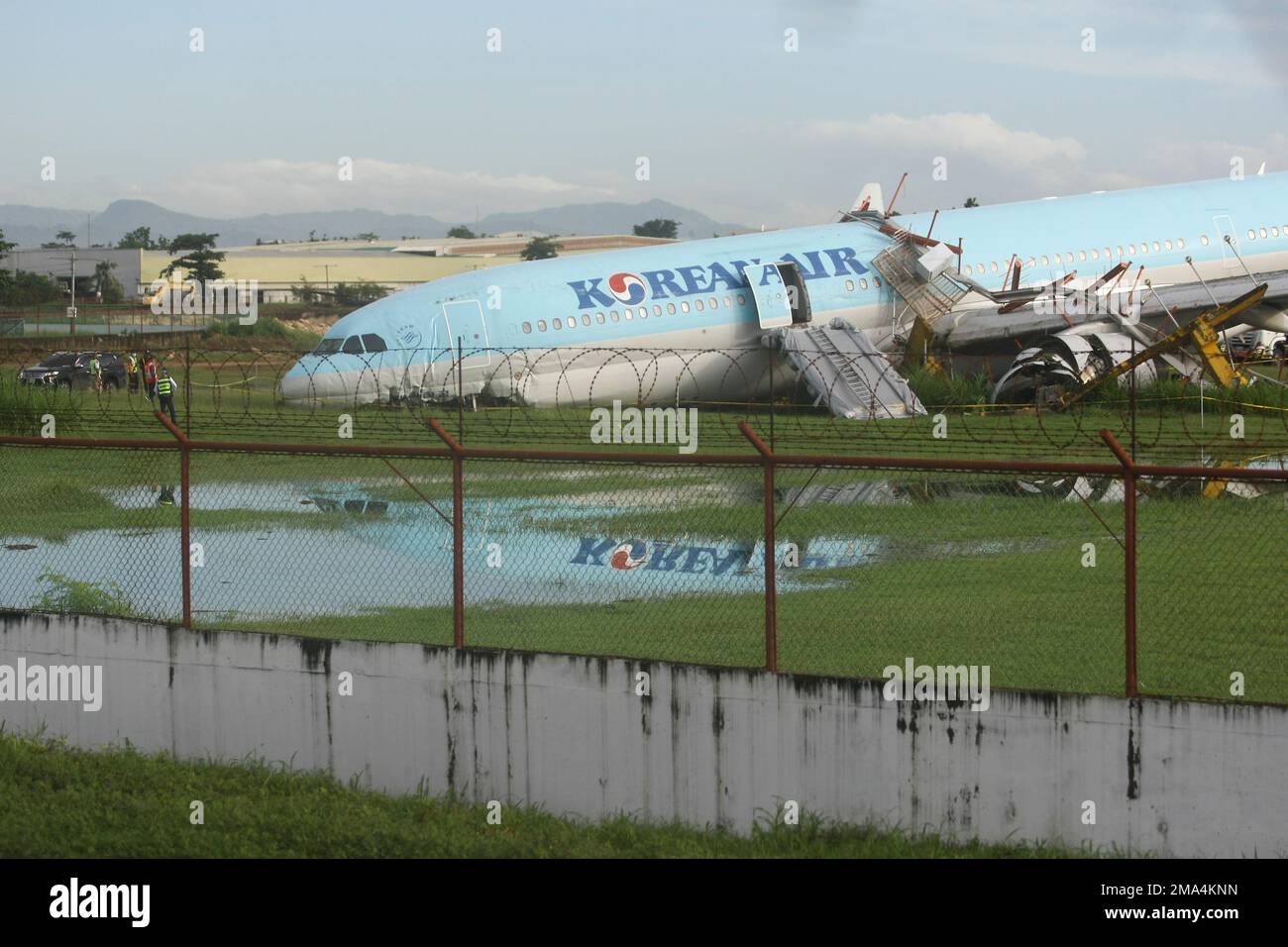 A damaged Korean Air plane sits after it overshot the runway at the Mactan-Cebu International ...