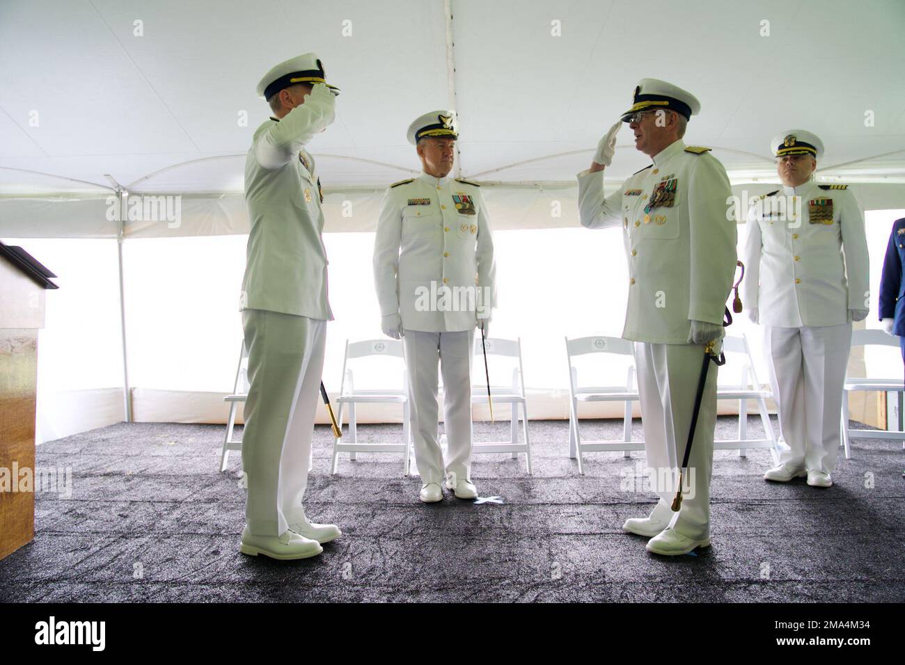 Vice Adm. Kevin Lunday salutes Vice Adm. Steven Poulin as he takes ...