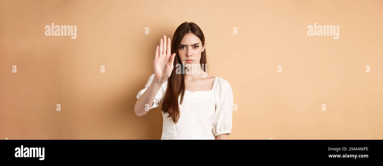 Nope stop right there. Serious and confident woman stretch out hand to ...