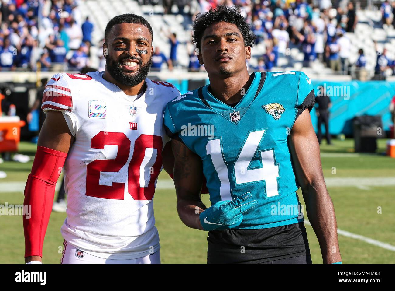 New York Giants safety Julian Love (20), left, and Jacksonville Jaguars ...