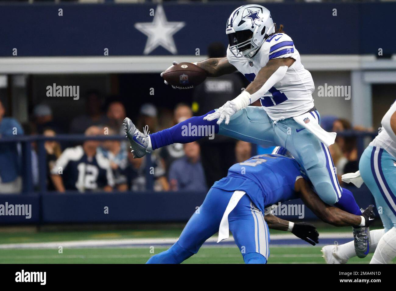 Dallas Cowboys running back Ezekiel Elliott (21) hurdles Detroit Lions ...