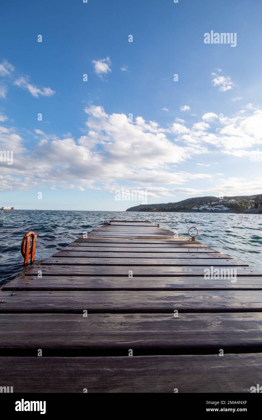 Path with wooden planks over the sea in the town of Cadaques where ...
