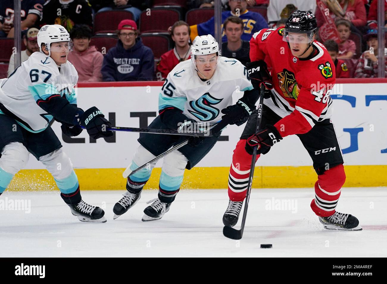 Chicago Blackhawks defenseman Filip Roos, right, controls the puck ...