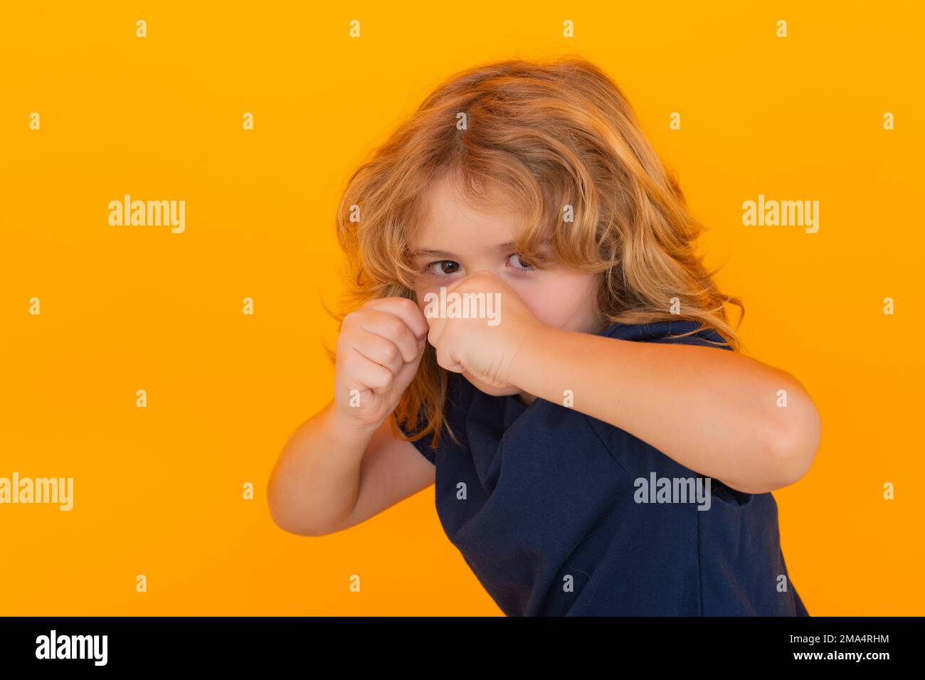 Angry child with fist gesture fight, hit on studio isolated background ...