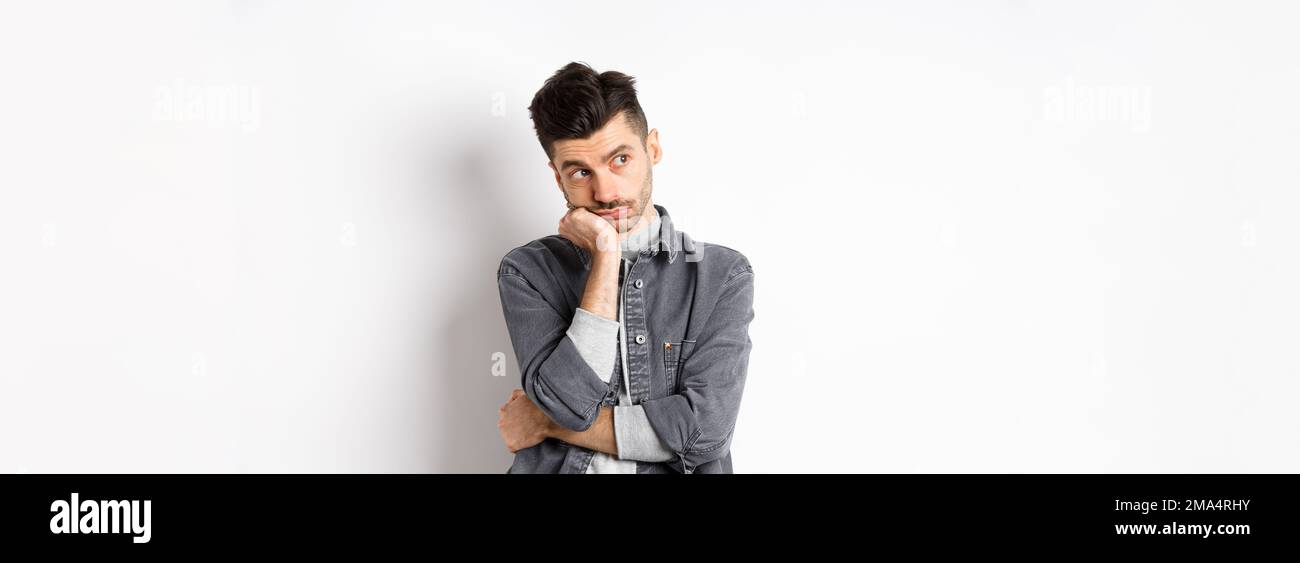 Gloomy thoughtful man looking aside, thinking or space out, staring at ...