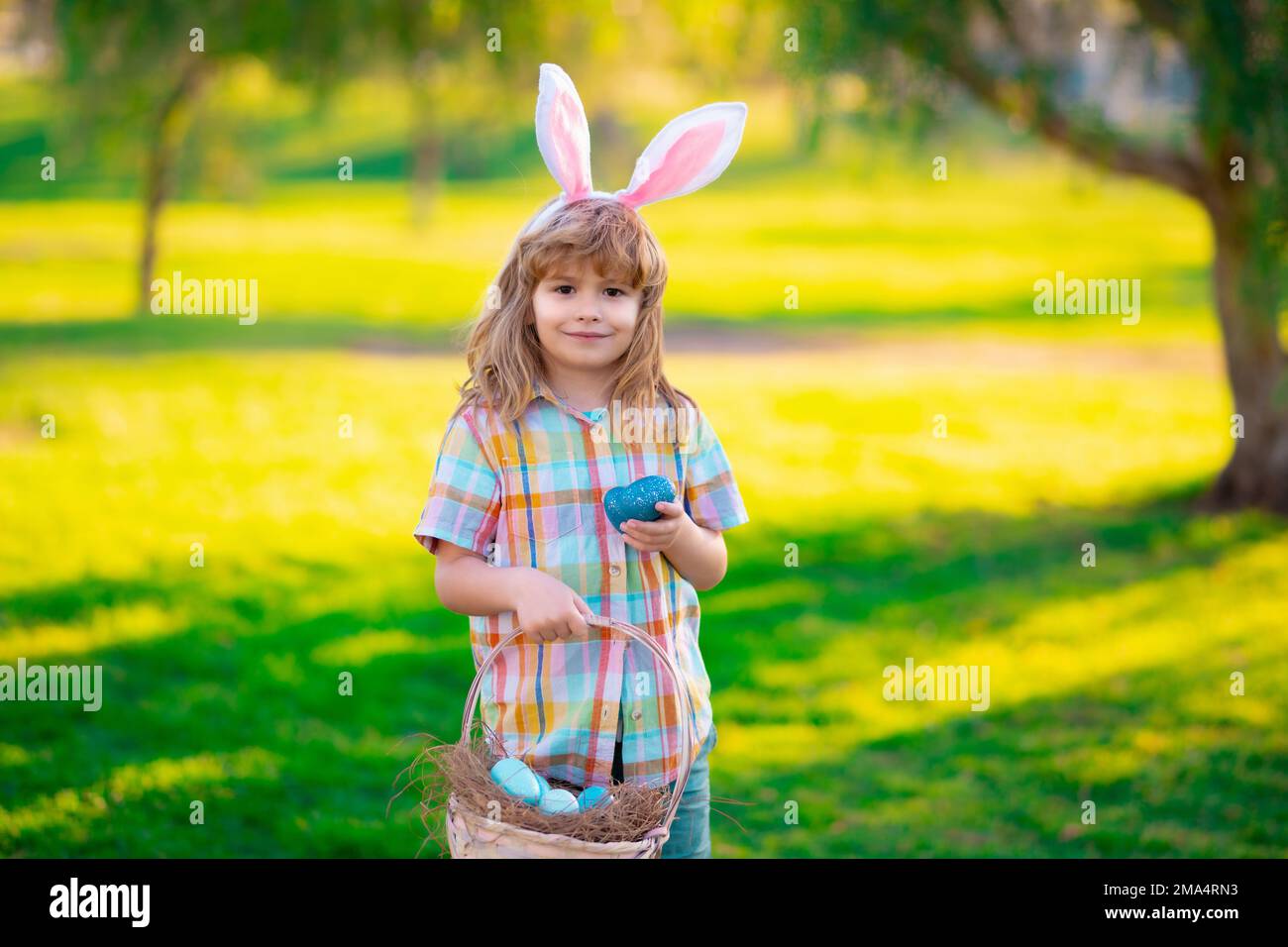 Easter kid in park. Child boy hunting easter eggs, laying on grass. Kid ...