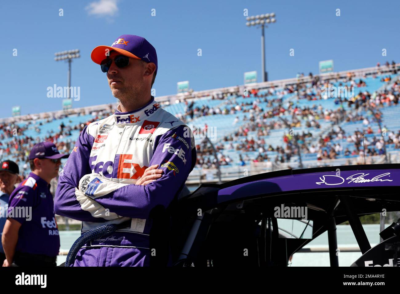 Driver Denny Hamlin leans on his car before a NASCAR Cup Series auto ...