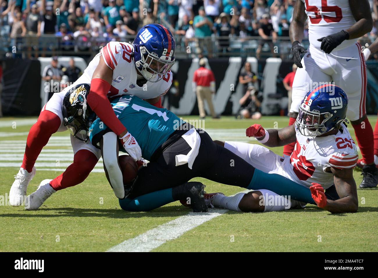 Jacksonville Jaguars running back Travis Etienne Jr. (1) scores past New York Giants safety ...