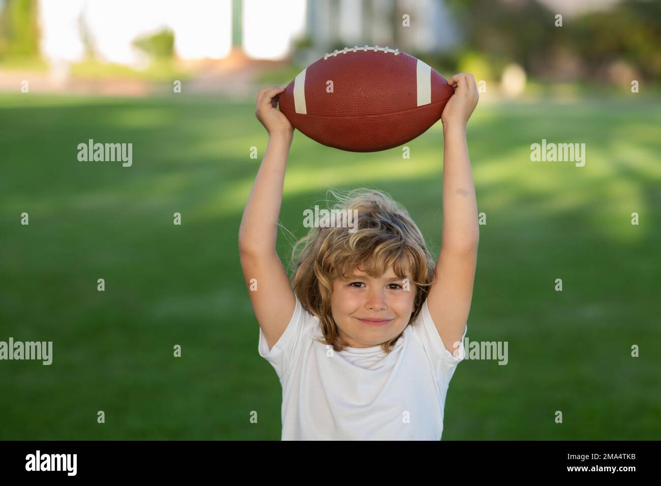 Football game, rugby, american football. Child boy playing football ...