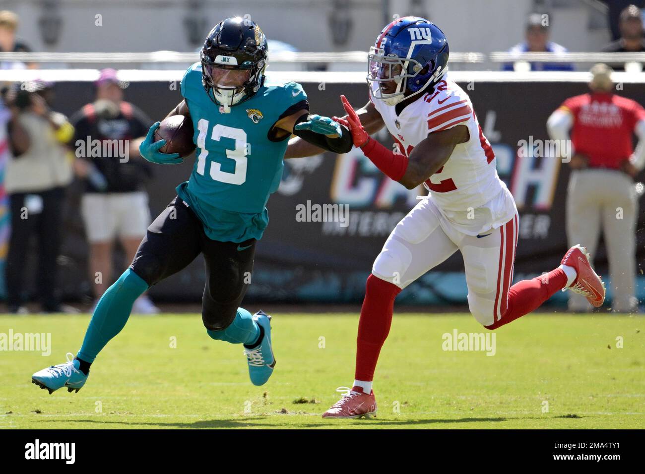 Jacksonville Jaguars wide receiver Christian Kirk (13) pushes past New York Giants cornerback ...