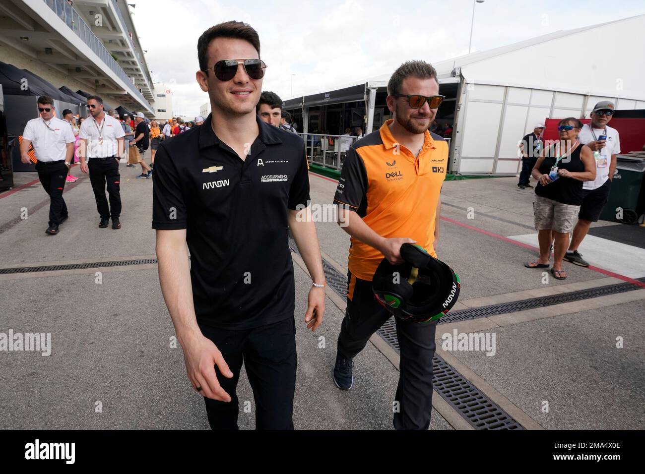 McLaren driver Lando Norris, of Britain, left, walks through the ...