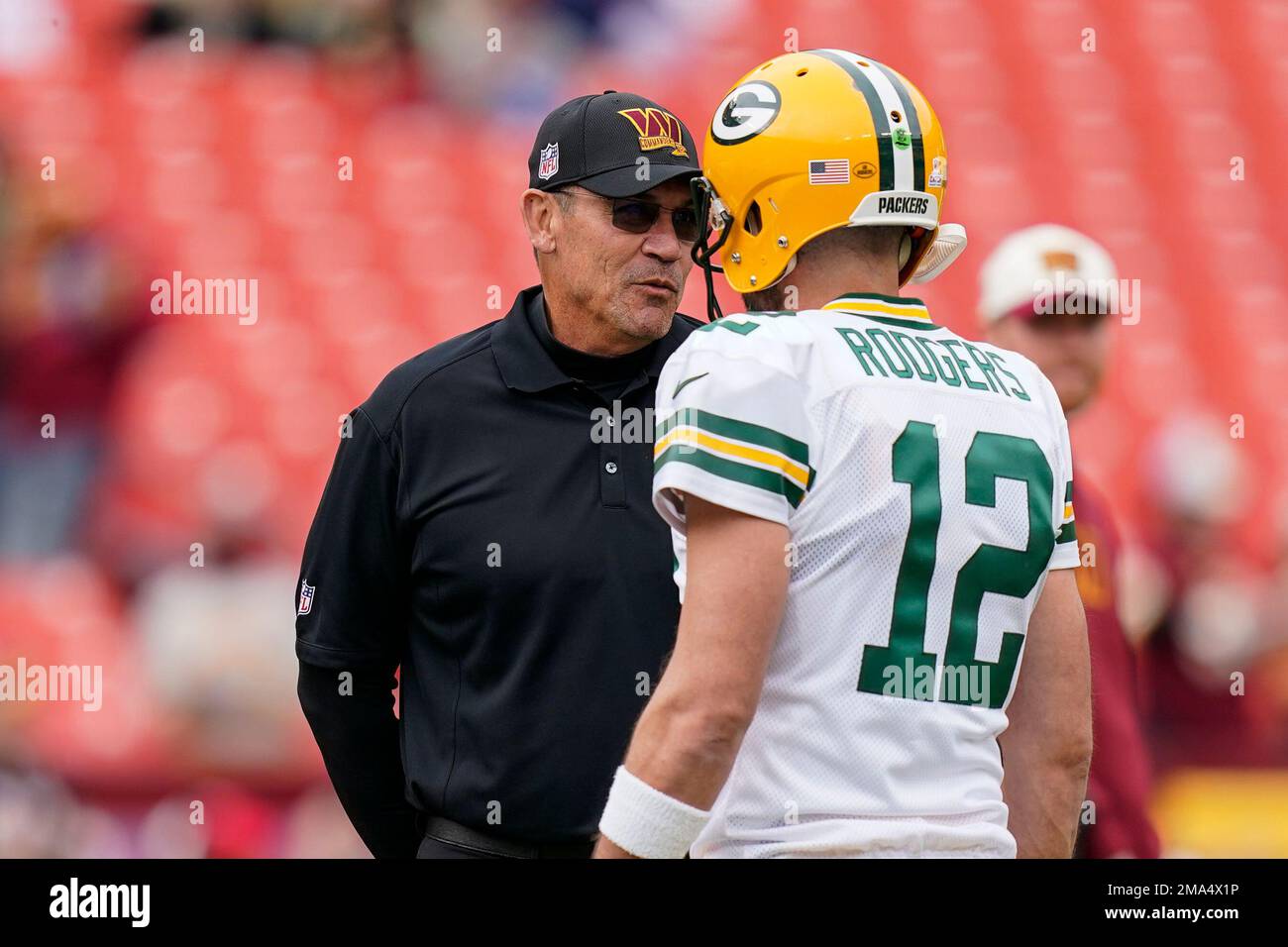 Washington Commanders head coach Ron Rivera, left, talks with Green Bay ...