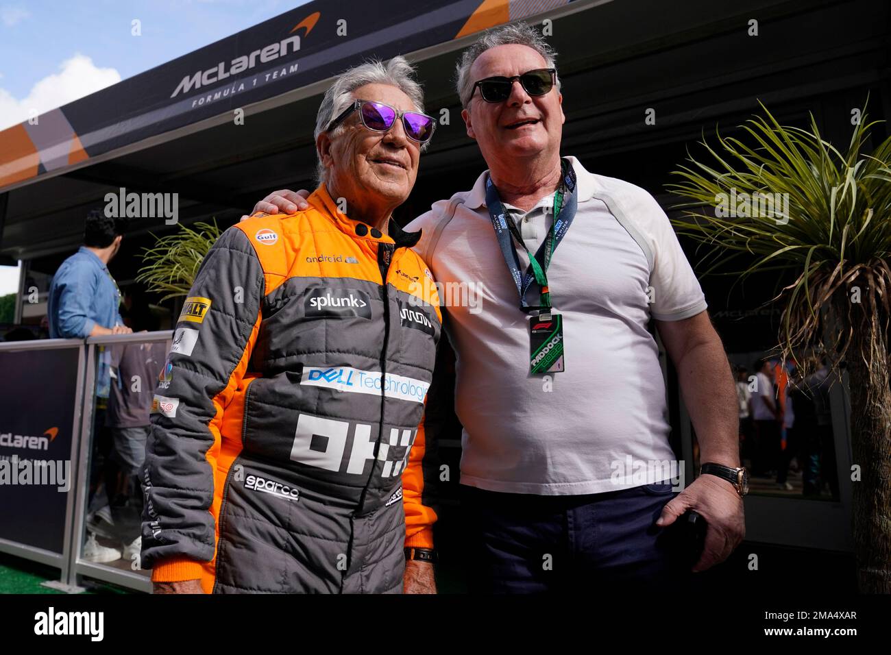 Racing great Mario Andretti, left, walks through the paddock before the ...