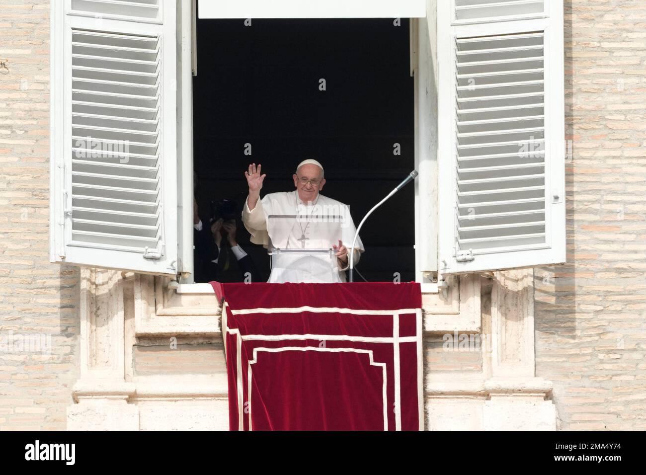 Pope Francis waves as he arrives for the Angelus noon prayer from the ...