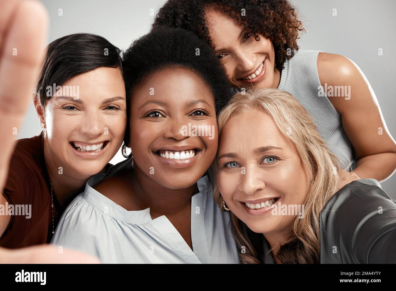 Smile for the camera. a diverse group of women standing close together ...