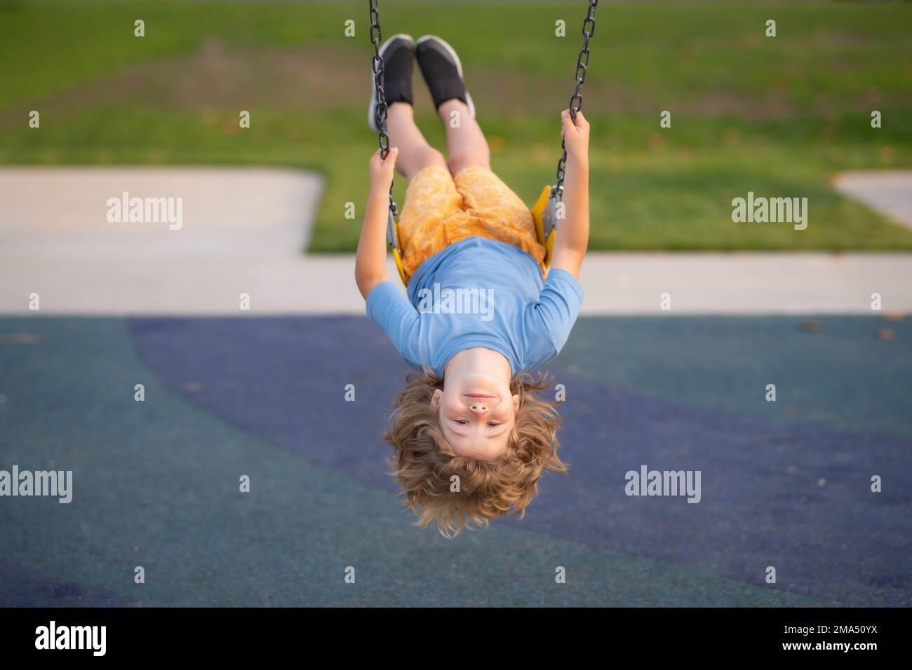 Playground. Kid swinging on swing on playground. Craziness and freedom ...