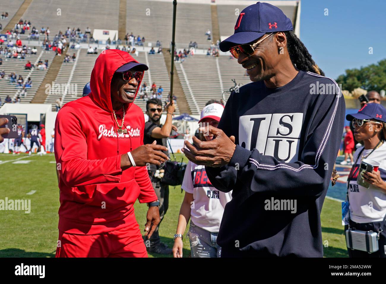 Jackson State head coach Deion Sanders, left, jokes with rapper Snoop ...