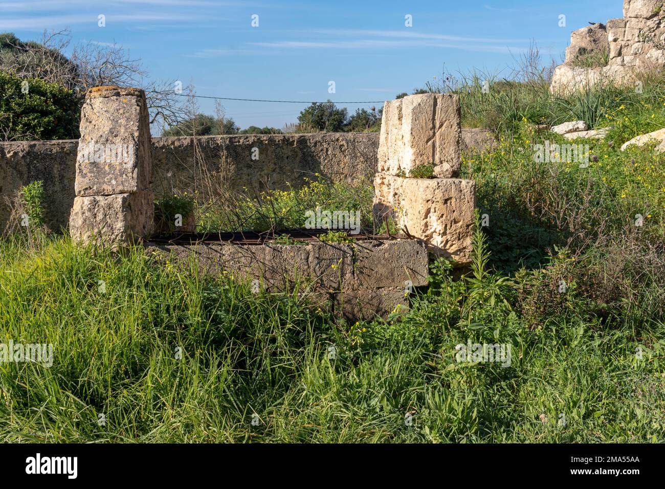 Old stone irrigation ditch and a well in disuse and in a ruinous state ...