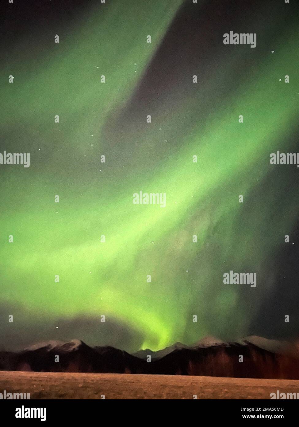 The northern lights are shown above the Chugach Mountains in Anchorage ...