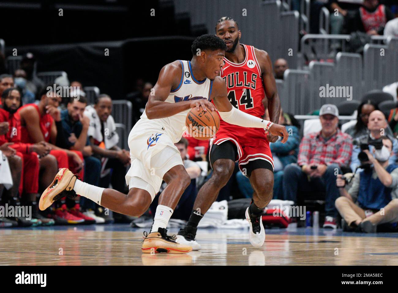 Washington Wizards forward Rui Hachimura, left, dribbles the ball past ...