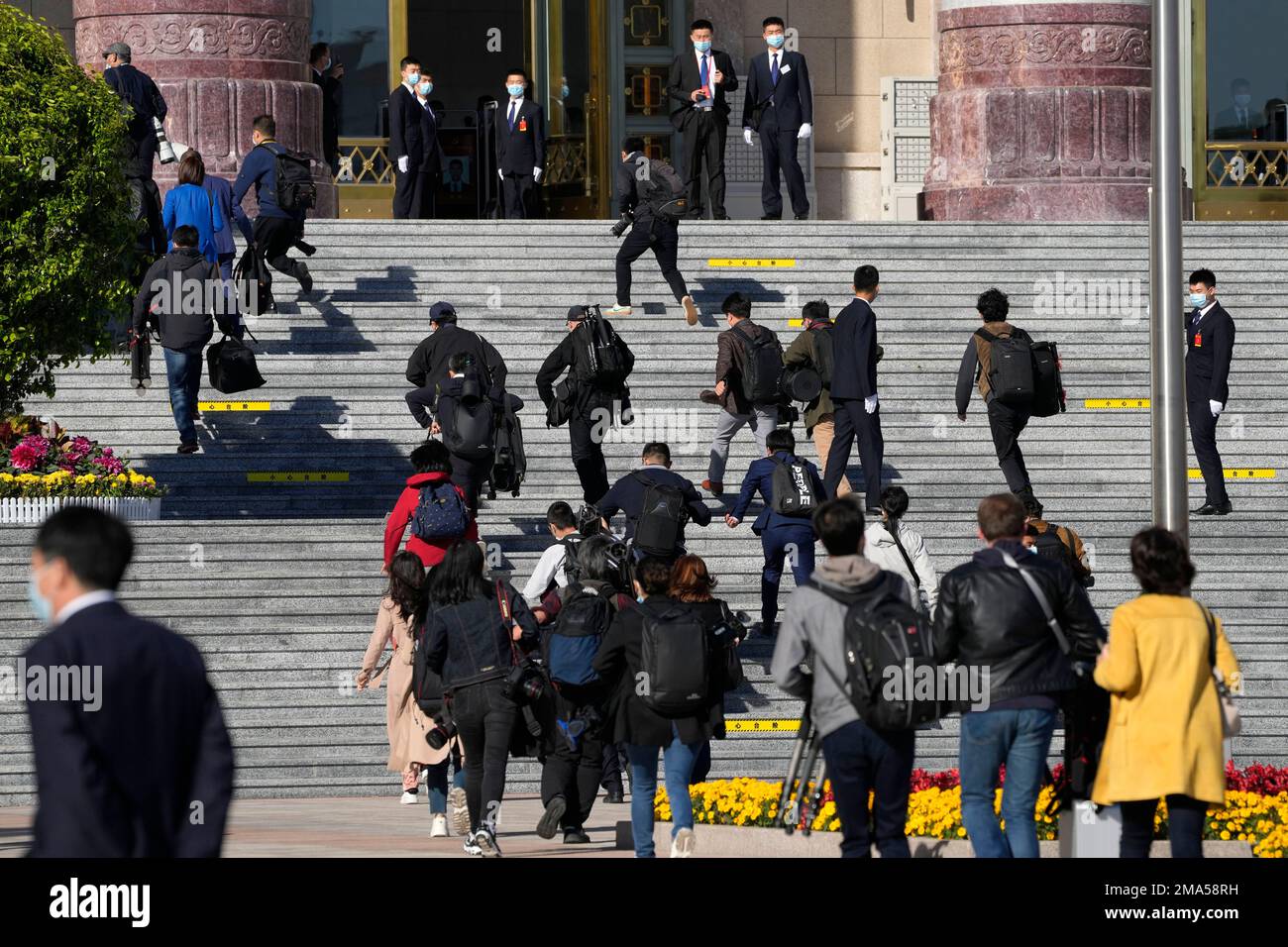 Journalists arrive ahead of the closing ceremony of the 20th National Congress of China's ruling ...