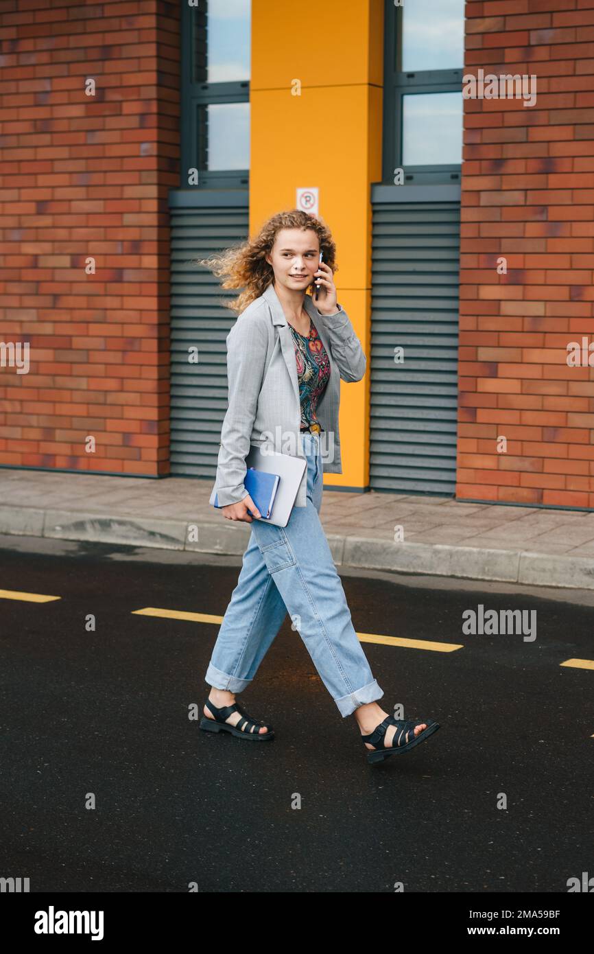 College student walking street mobile hi-res stock photography and ...