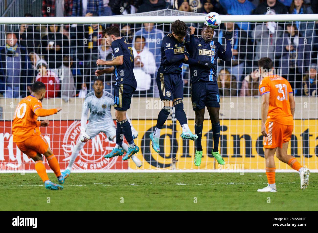 Philadelphia Union's Cory Burke, second from right, heads the ball away ...