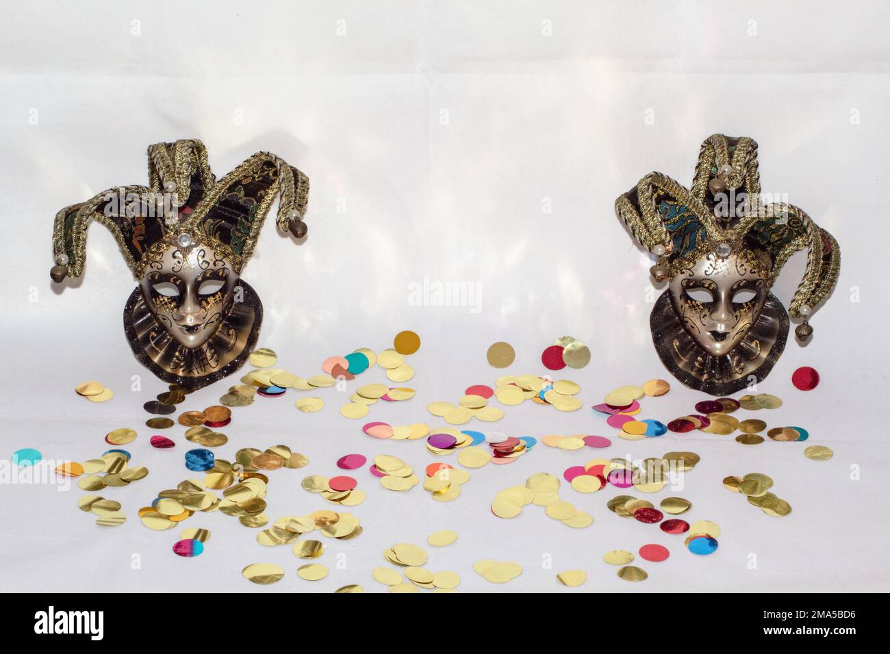 Pair of Venetian masks on a white Carnival-themed background with ...