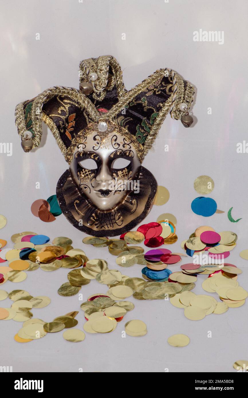 Venetian mask on a white Carnival-themed background with colored ...