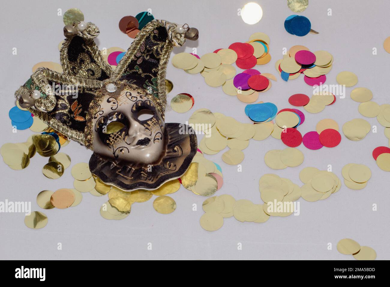 Venetian mask on a white Carnival-themed background with colored ...