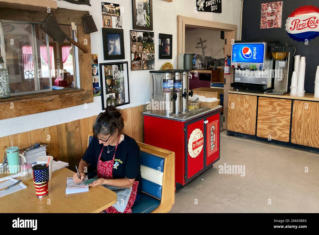 Shorty's BBQ stand co-founder Leanne Tapia pays bills during an ...