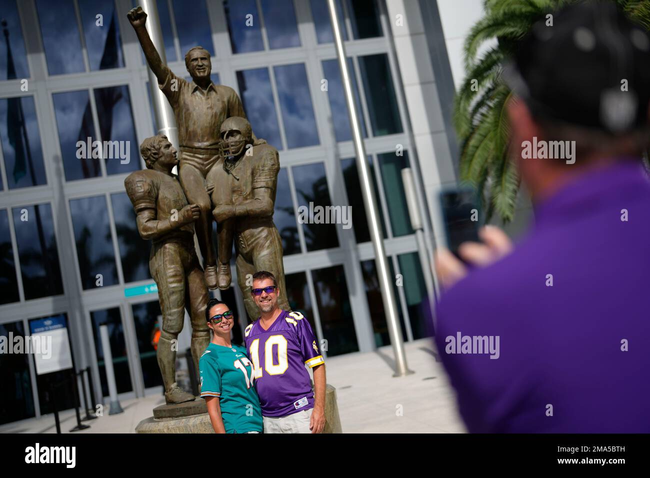 Miami Dolphins fan Susan Fusaro, left, gets her photo taken with fiance ...
