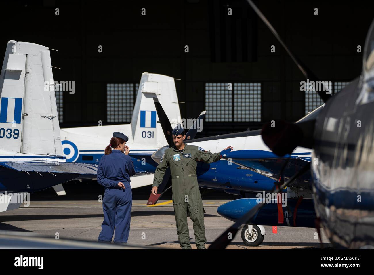 A Greek Airforce Pilot speaks with a ground staffer in front of T-6 ...