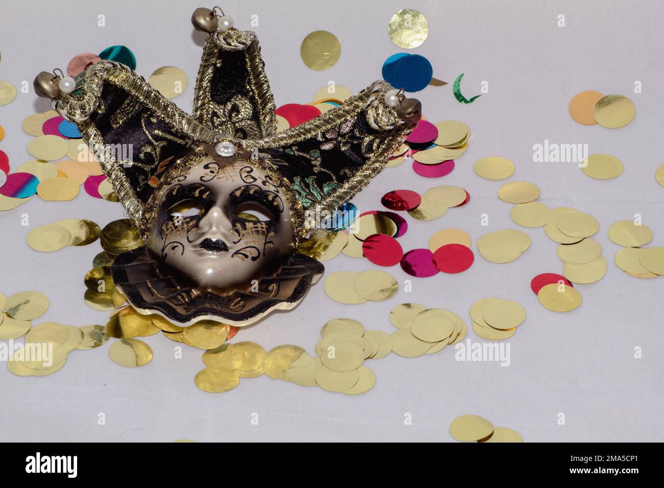 Venetian mask on a white Carnival-themed background with colored ...